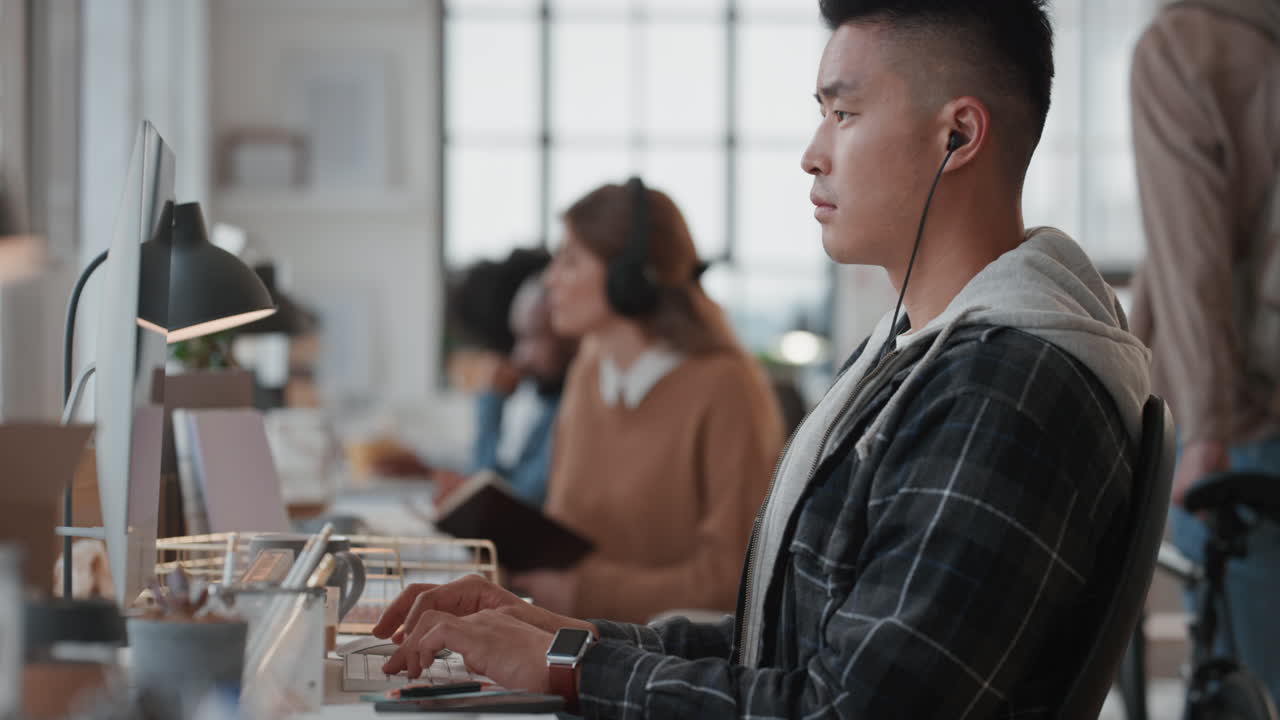 Young asian man software developer using computer designing mobile ...