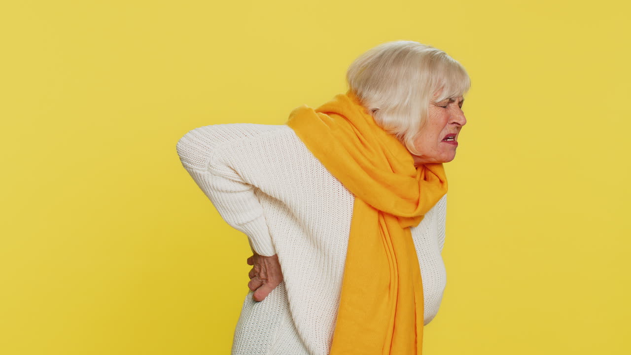 Senior old woman touching injured sore back, backache, suffering lower ...