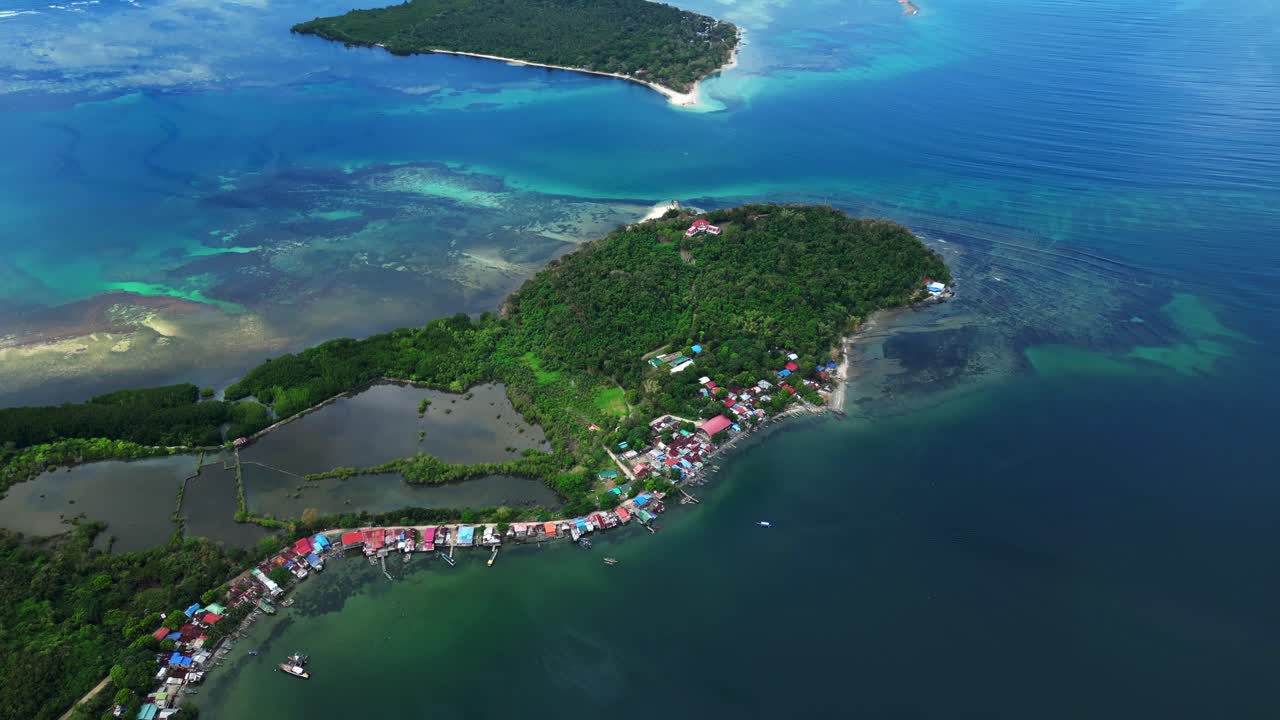 Drone approaches Luan Island along coastline showing white beaches and ...