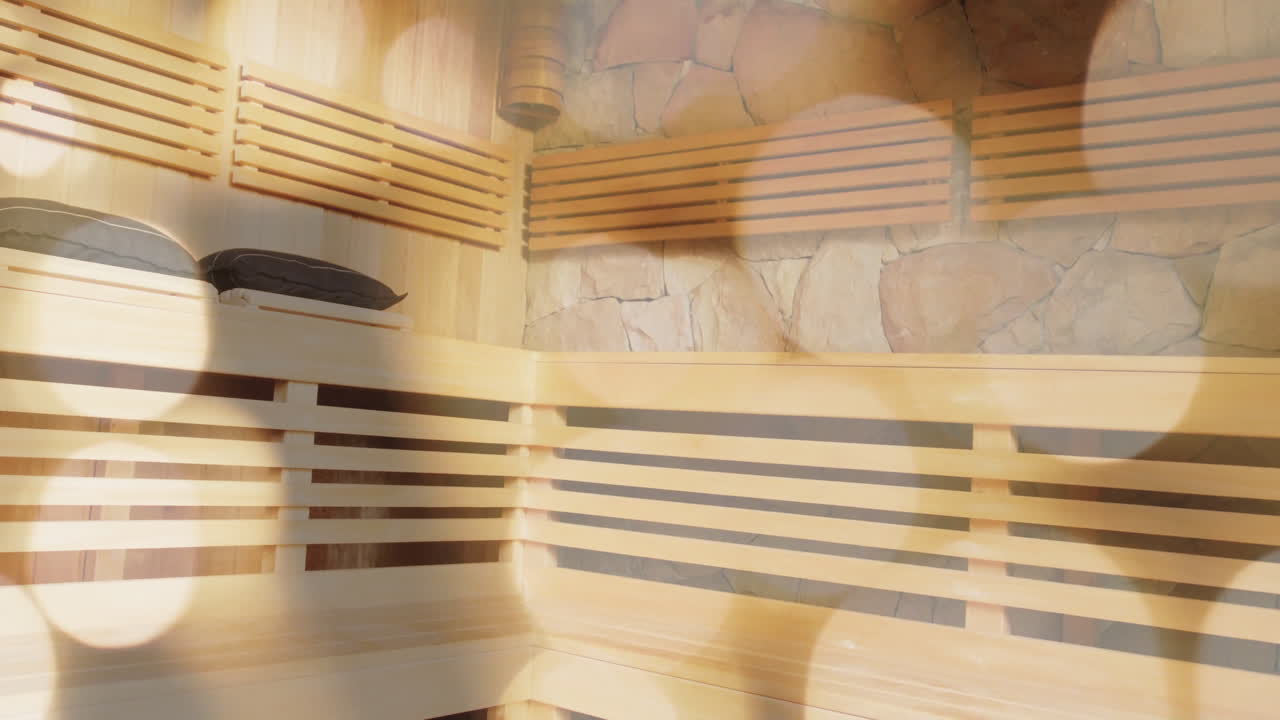 Light bokeh animation over empty wooden sauna interior with stone wall ...