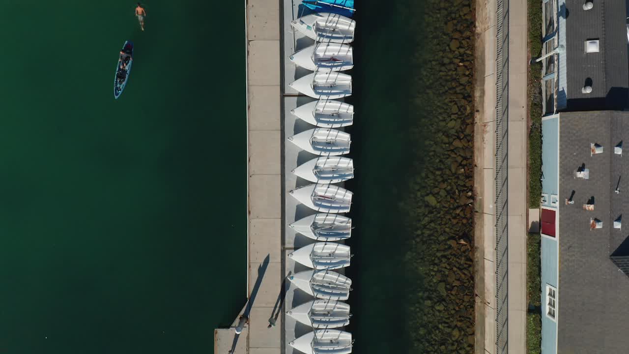 Top Down Aerial View Of Small Sailboats Tied Up To A Dock Free Stock ...