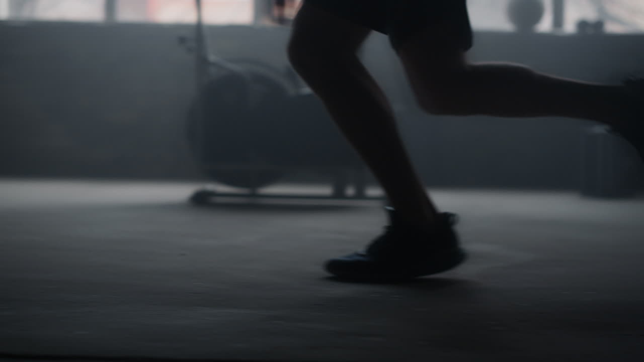 Athlete standing on start position. sportsman legs running fast in gym ...