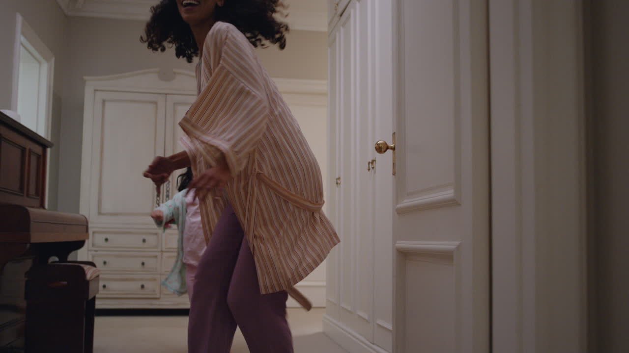 Premium stock video - Happy little girl chasing mother and daughter ...