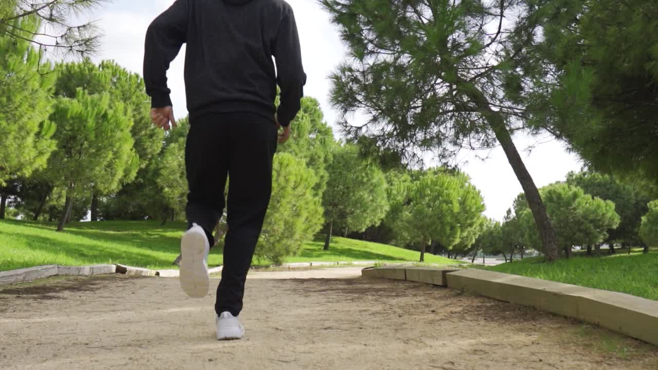 Premium stock video - Man running back camera tracking motion nature