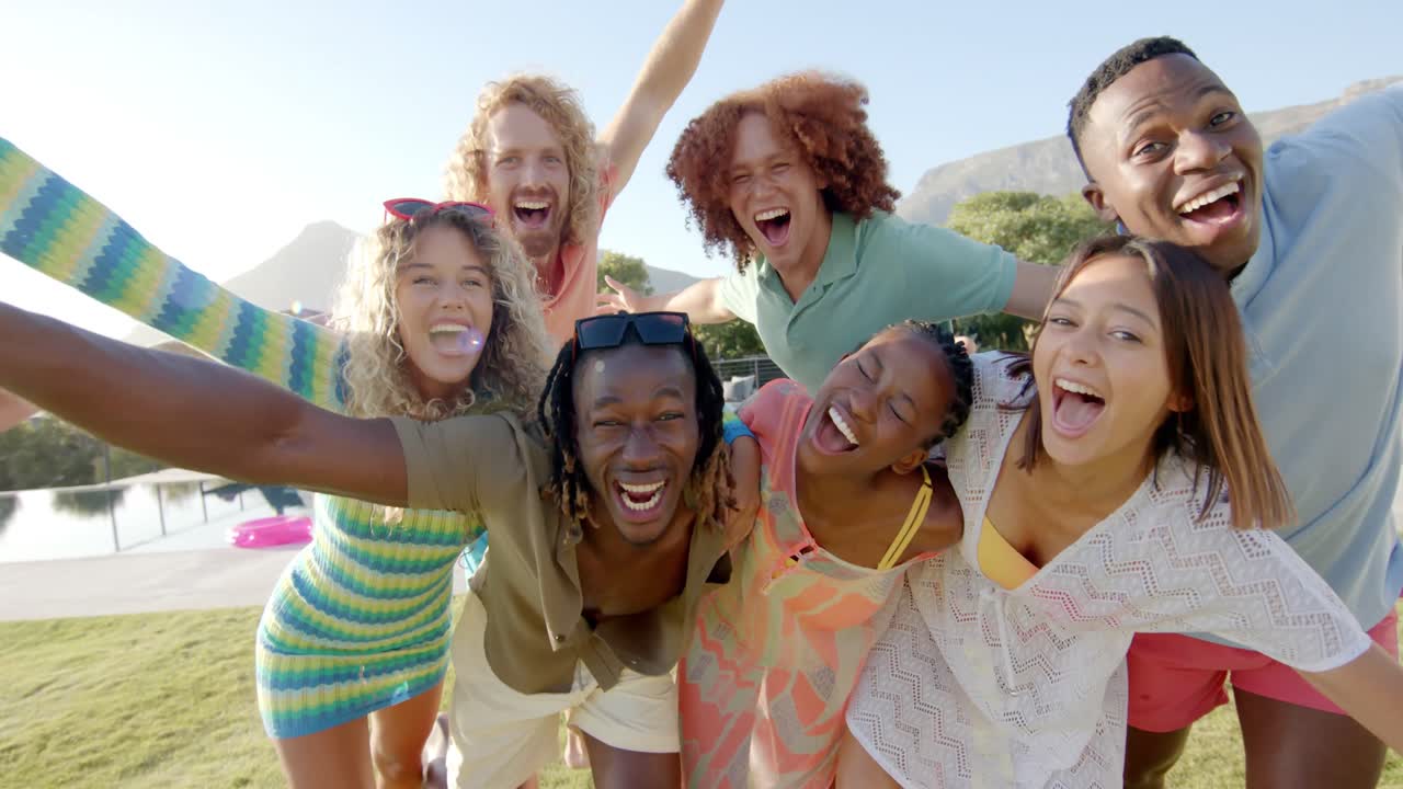 Portrait of happy diverse friends embracing and having fun at sunny ...