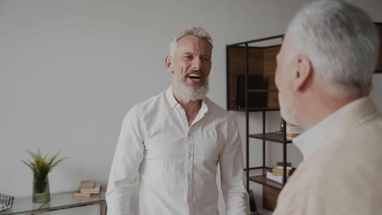 Two Happy Senior Men Friends Talking And Laughing At Home | Free Stock ...