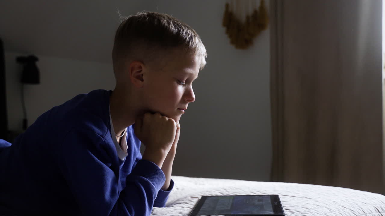 Free stock video - Kid watching video on tablet