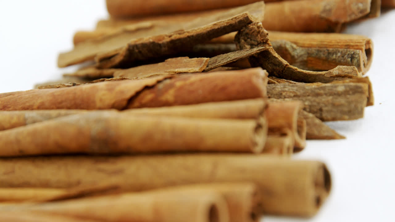 Premium stock video - Cinnamon on white background 4k