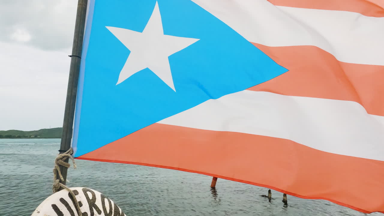 Dolly Forward Shot Along Jetty Overlooking Sea Rising Up To A Flag Of ...
