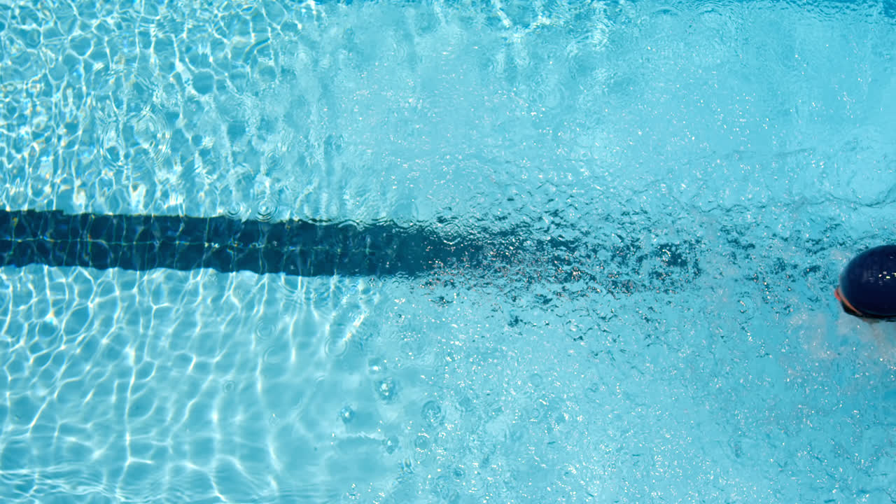 Premium stock video - Male swimmer swimming inside pool 4k