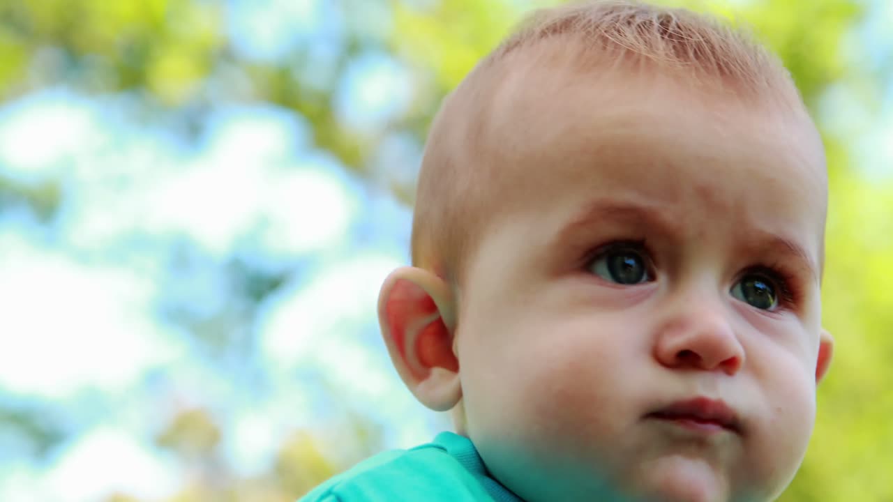 Premium stock video - Cute baby boy looking around