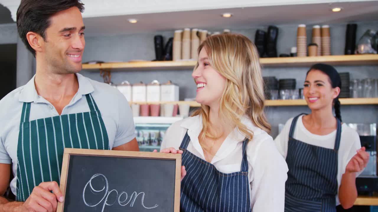 Team Of Waiter And Waitress Posing With Open Sign Free Stock Video ...