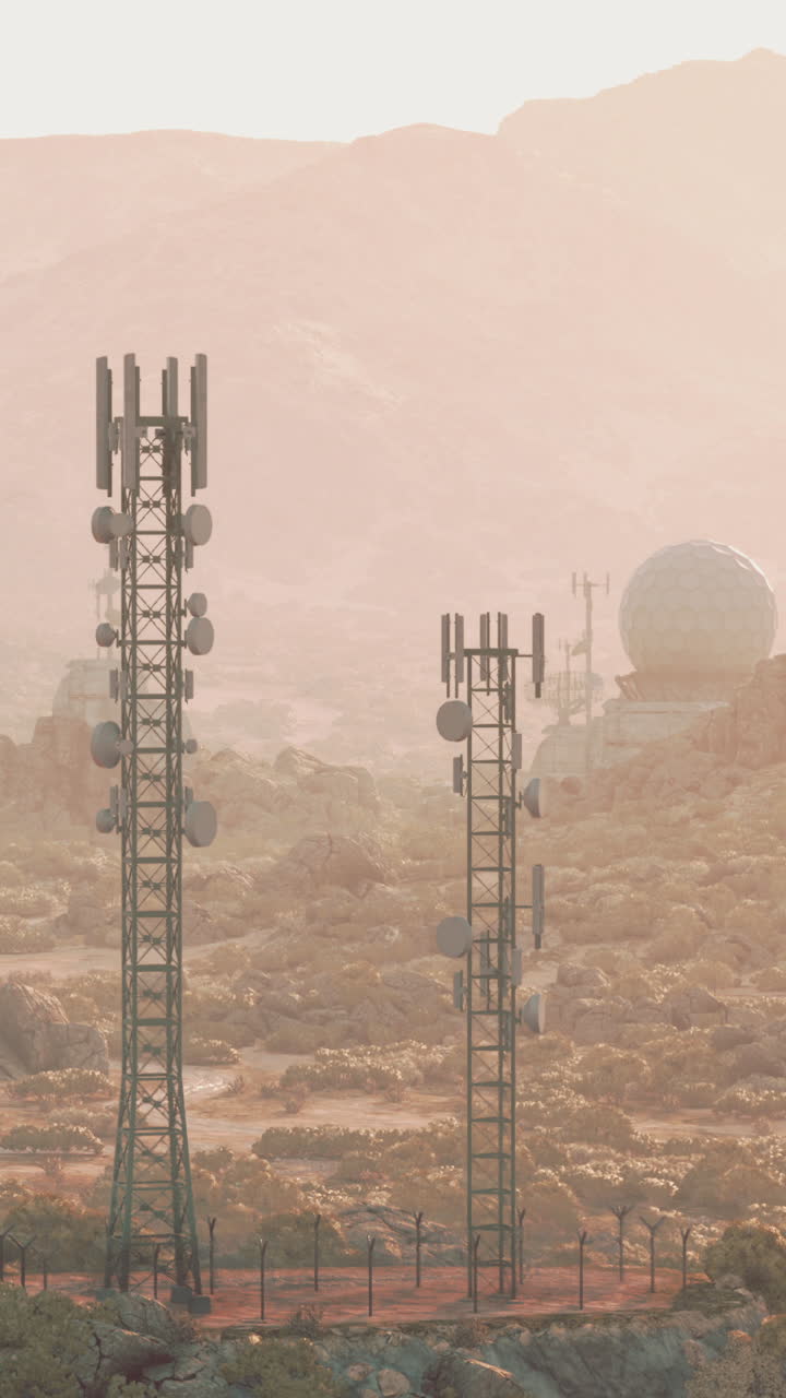 Premium stock video - A pair of cell towers in a desert landscape
