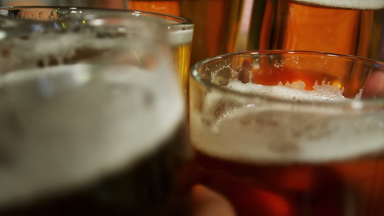 Premium stock video - Friends toasting with their pint