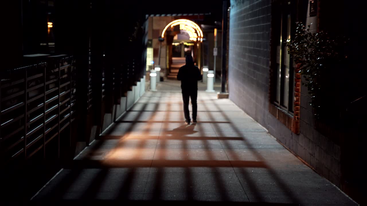 Man walking in the street at night | Premium Stock Video Footage