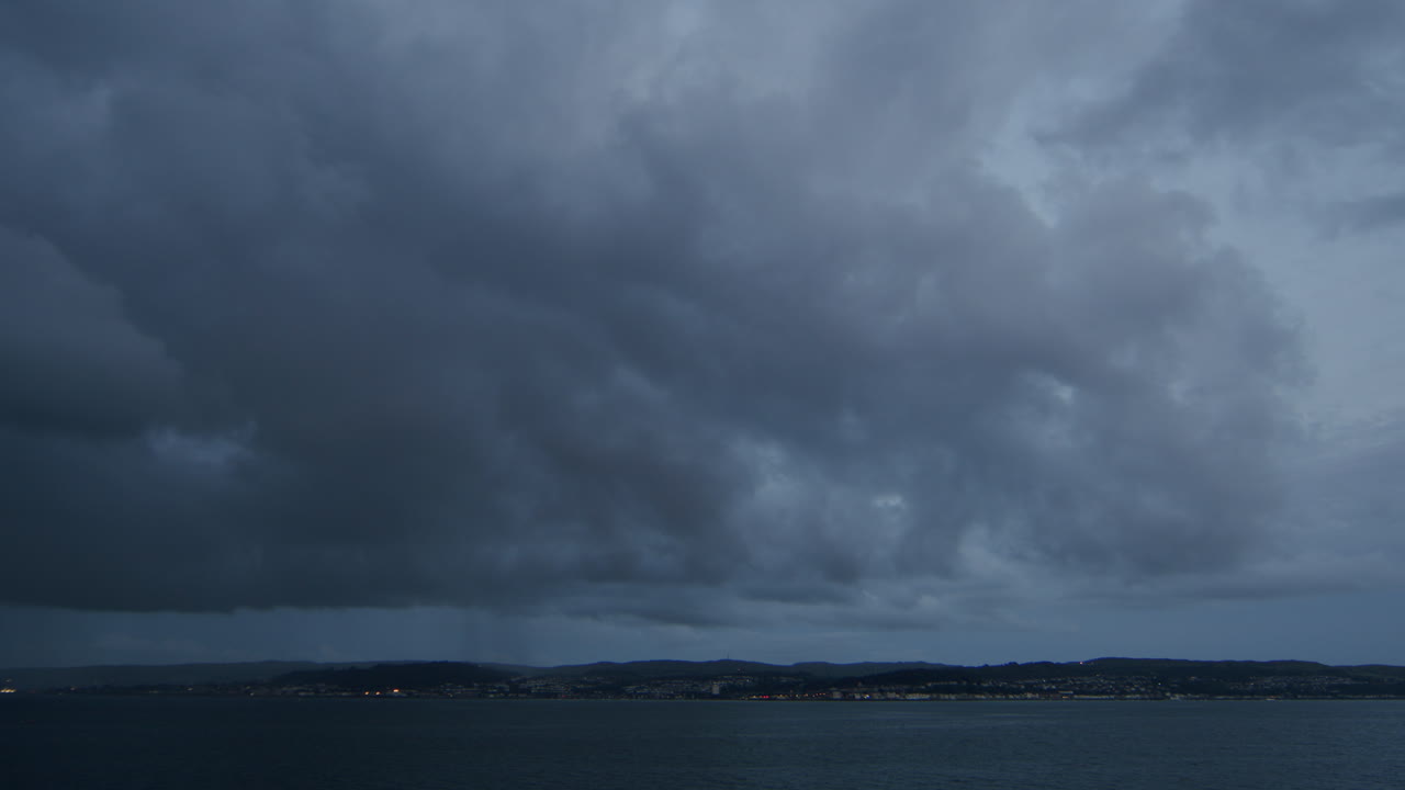 Heavy Clouds And Rain Passing Over Seaside Town And Water, Timelapse ...