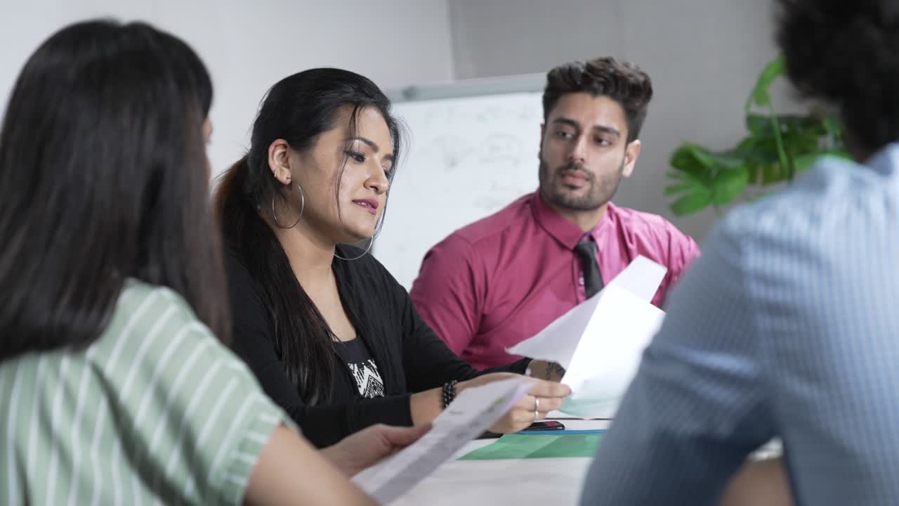 Indian female coach sitting holding meeting with diverse work ...