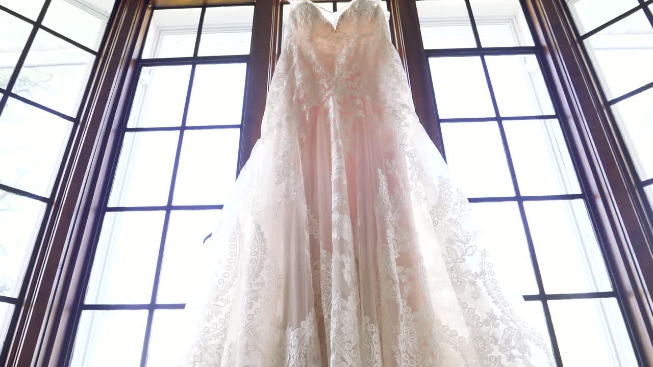 Elegant Wedding Dress Hanging In Window, Revealing Shot Of Beautiful ...