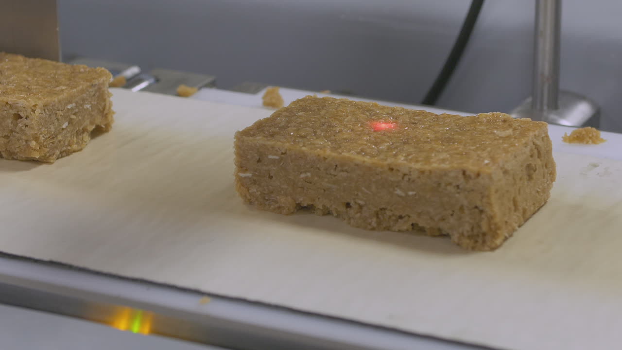 Premium stock video - Flapjacks cake bars move along a conveyor ...