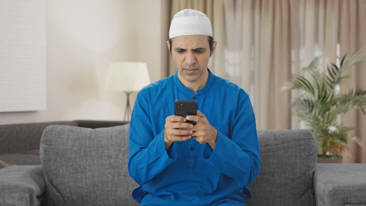 Angry Muslim man texting on phone | Premium Stock Video Footage