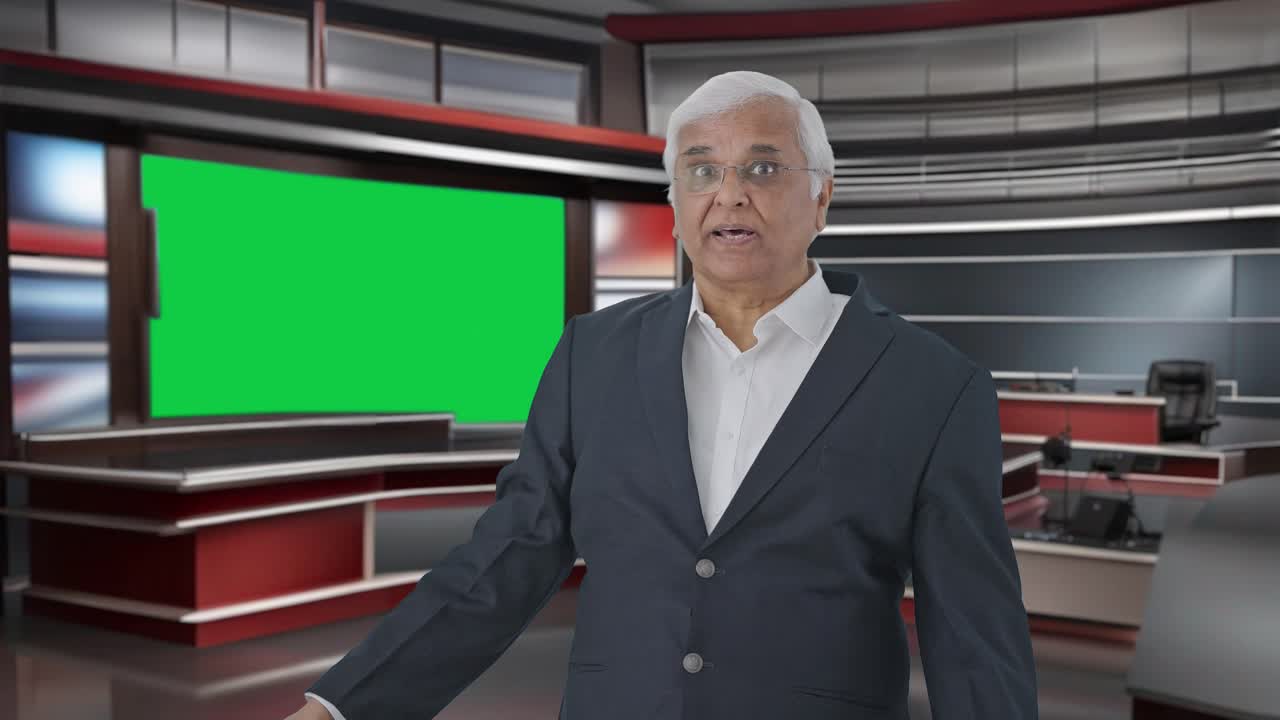 Premium stock video - Indian senior journalist pointing at green screen ...