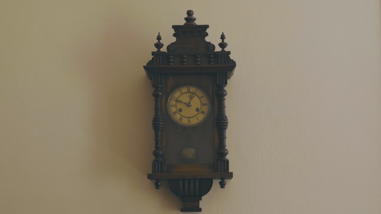 Premium stock video - A grandfather clock hanging on the wall reads 12: ...