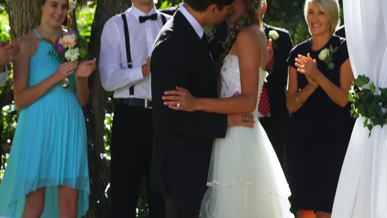 Premium stock video - Bride and groom hugging each other, guest ...