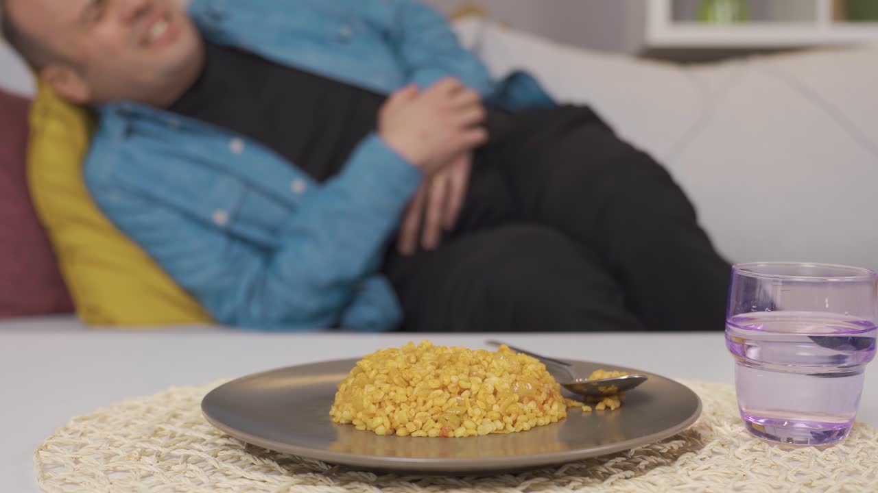 Premium stock video - Food poisoning. the man is poisoned by the food ...