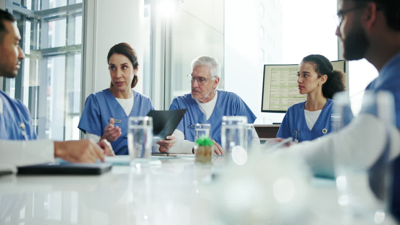 Medical professionals discussing an x-ray Premium Stock Video Footage
