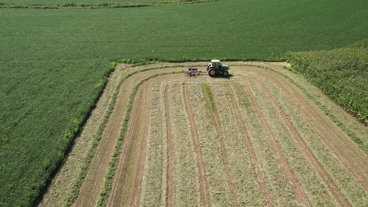 On A Farm Field In Southwest Wisconsin, A Farmer Rakes Hay Using A ...