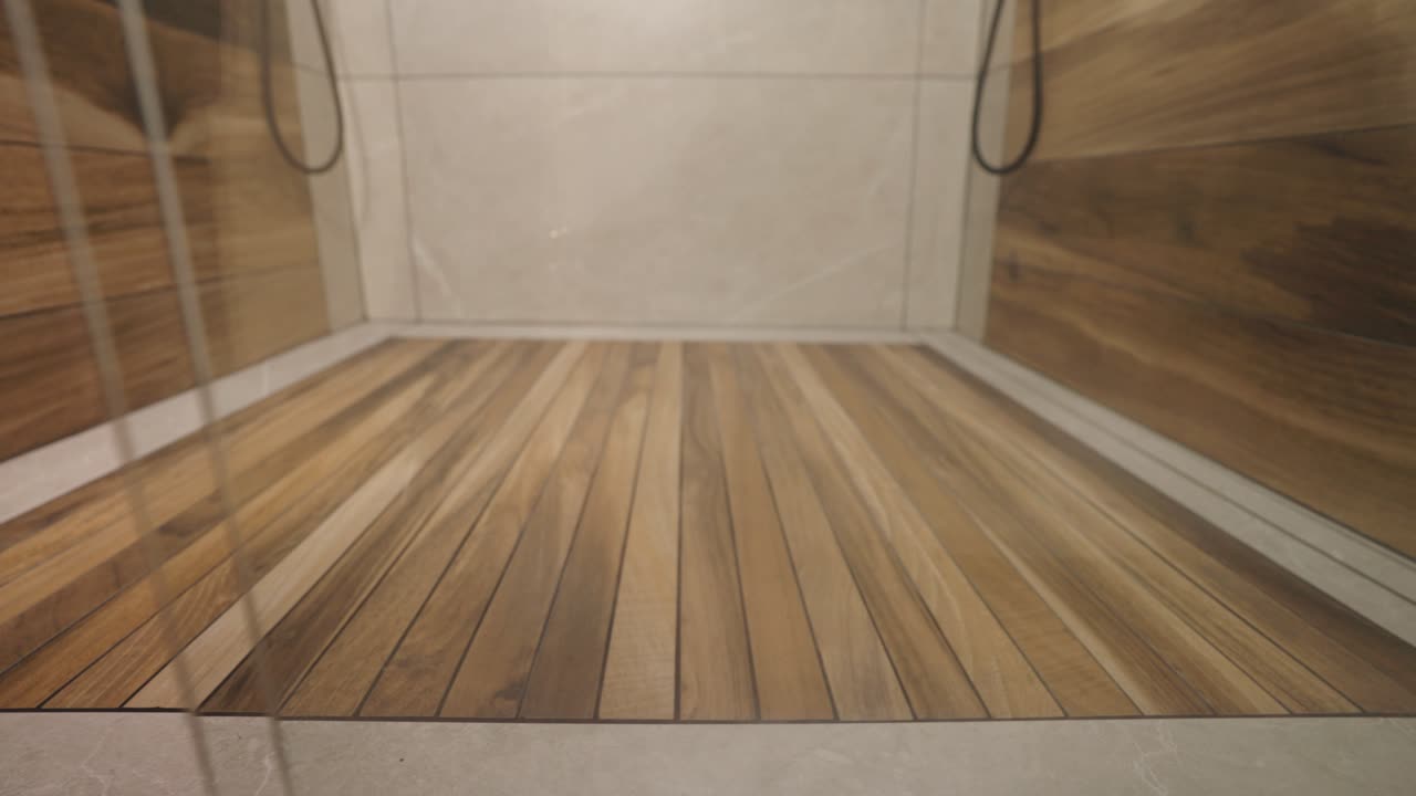 Premium stock video - Profile view of wooden slat shower floor in bathroom