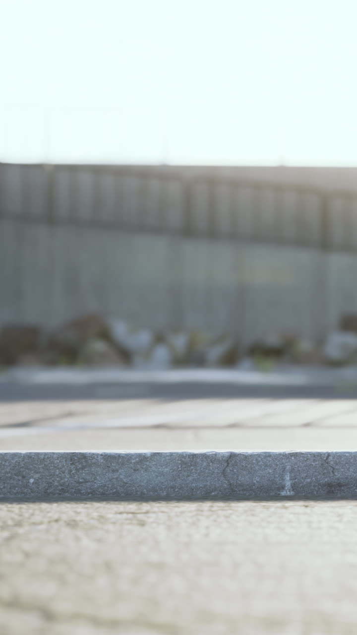 Close-up of a concrete curb with a blurred background of a street ...