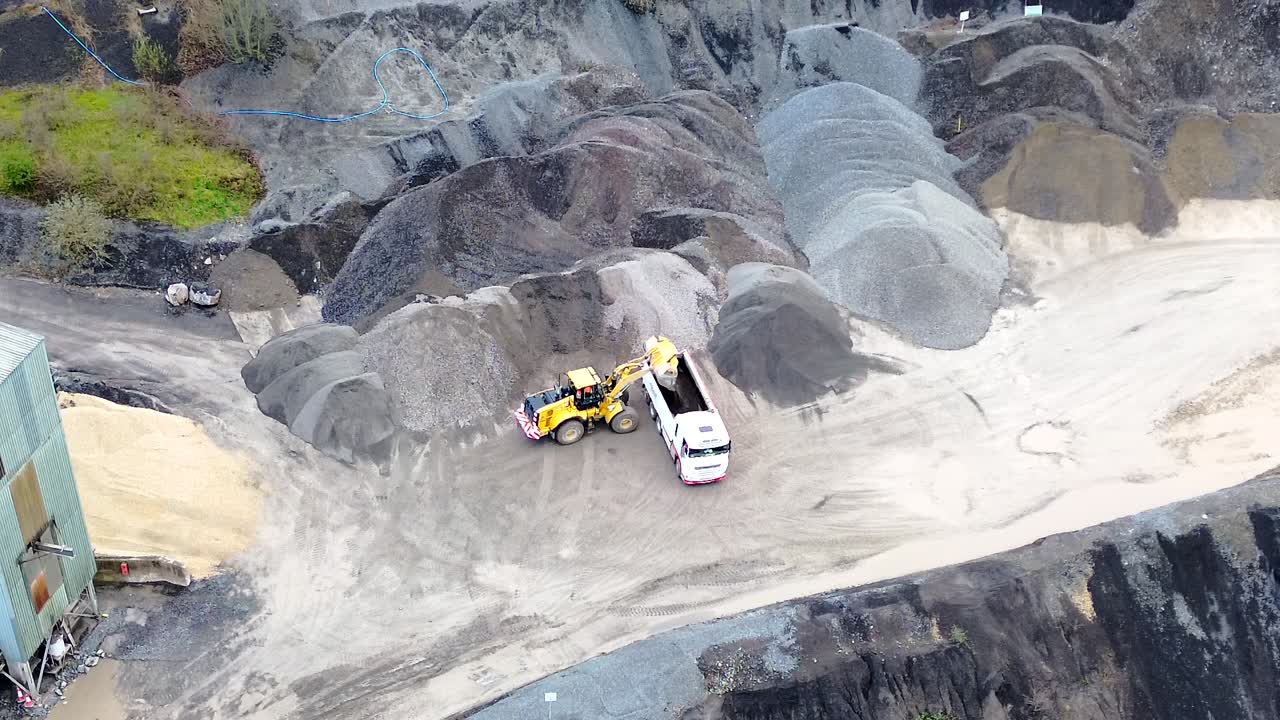 Tipper loading lorry with gravel in quarry Premium Stock Video Footage