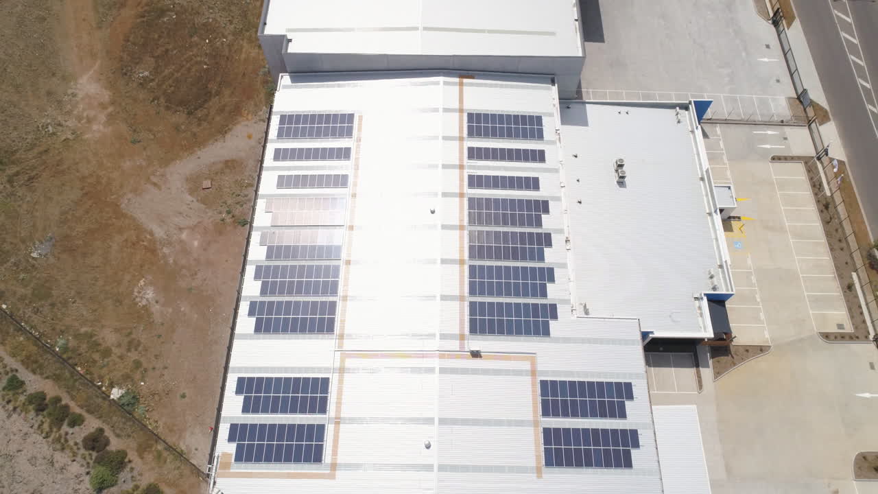 Solar panel installation on warehouse roof Premium Stock Video Footage