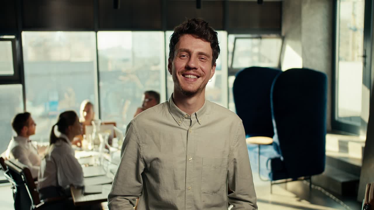 Premium stock video - Happy guy office worker in a white shirt posing ...