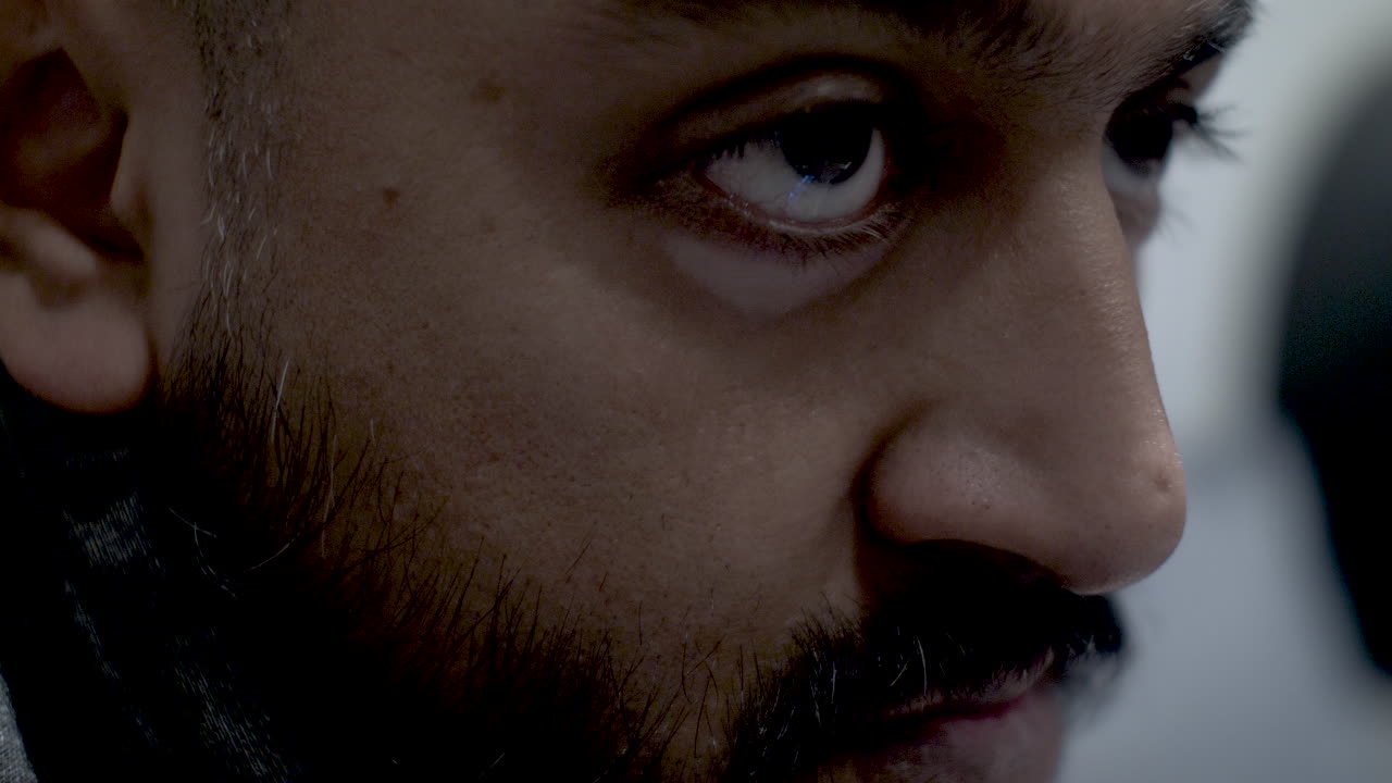 Extreme close up shot of the face of an Indian man, his focused eyes ...