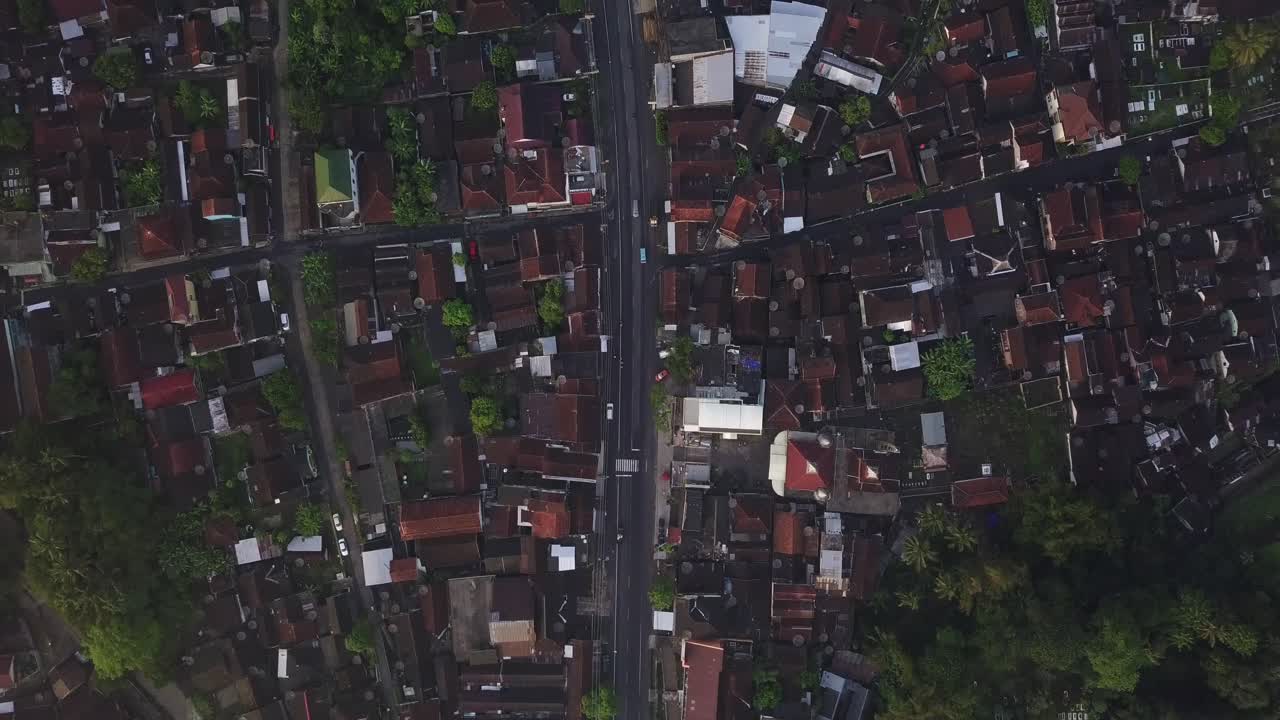 Overhead drone shot of densely populated settlement with a highway in ...