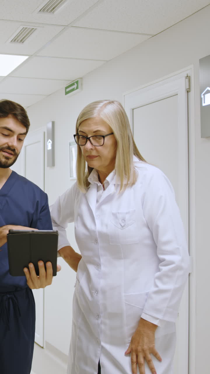 Doctors review medical information | Premium Stock Video Footage