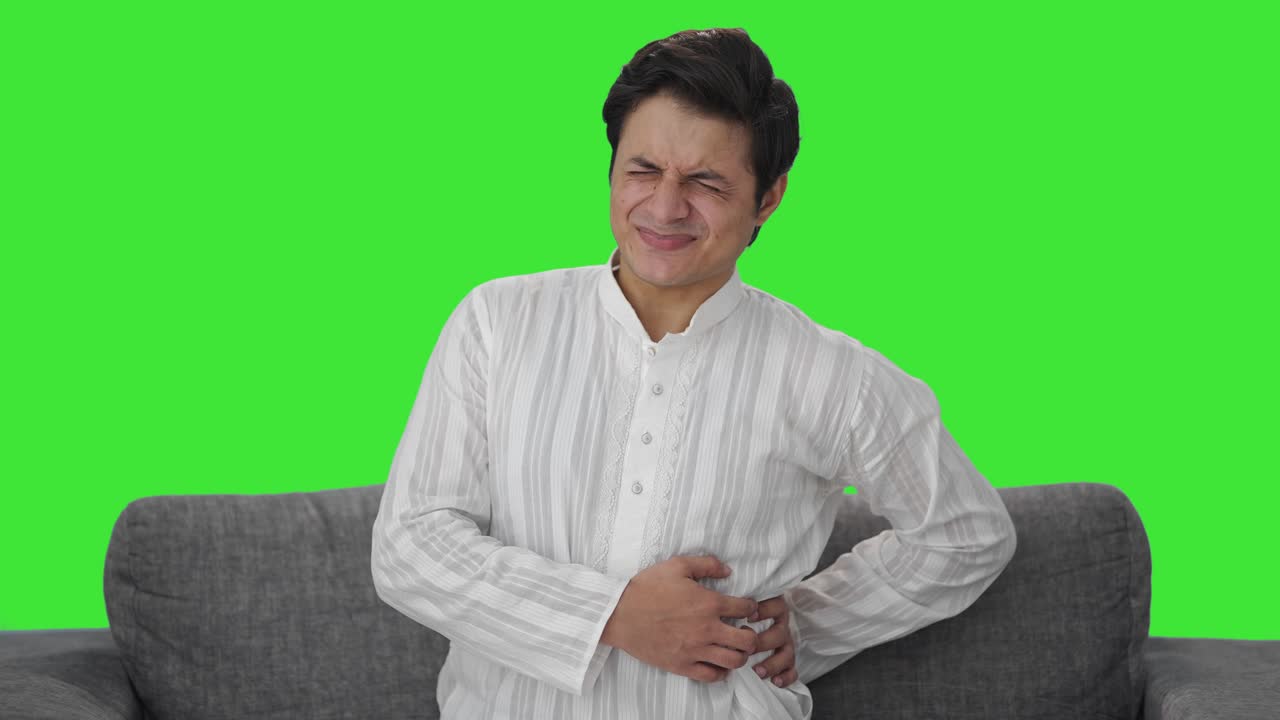 Premium stock video - Sick indian man having back pain green screen
