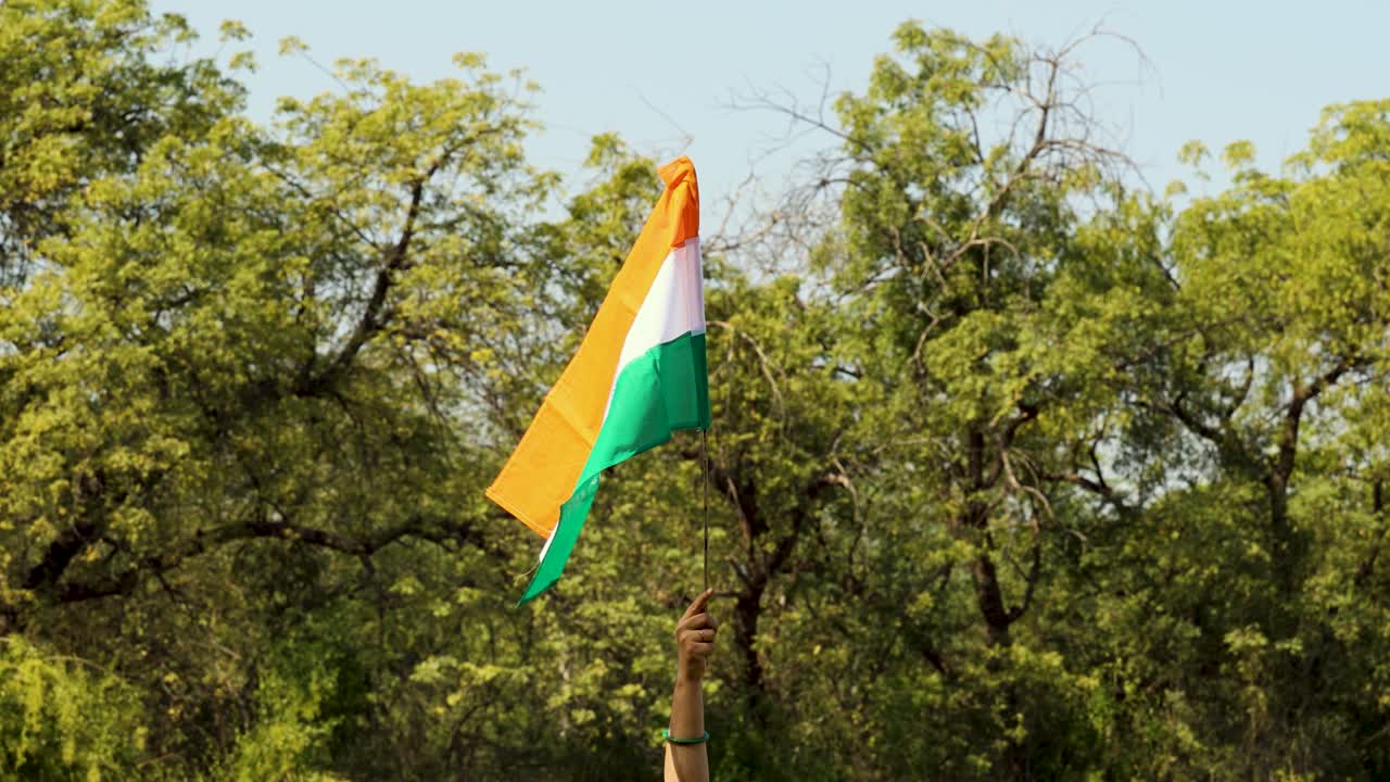 Premium stock video - Indian tricolor national flag holing in hand with ...