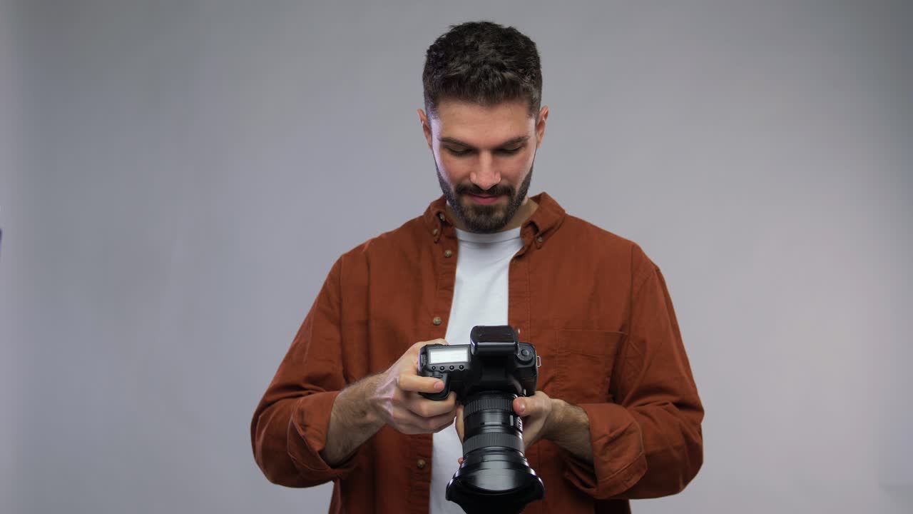 Premium stock video - Male photographer taking studio portraits on ...