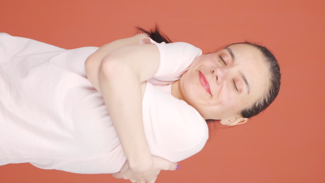 Premium stock video - Vertical video of the woman hugs the camera.