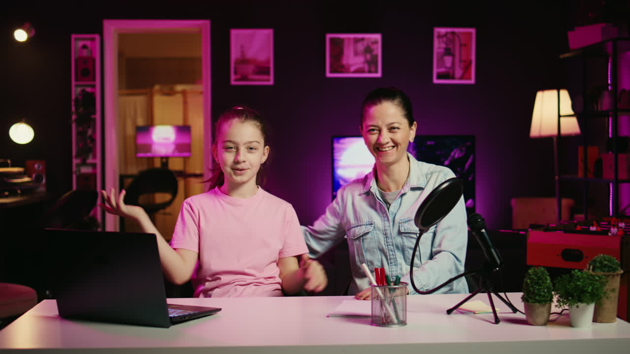 Young smiling daughter and parent warmly welcoming dedicated gen z fans ...