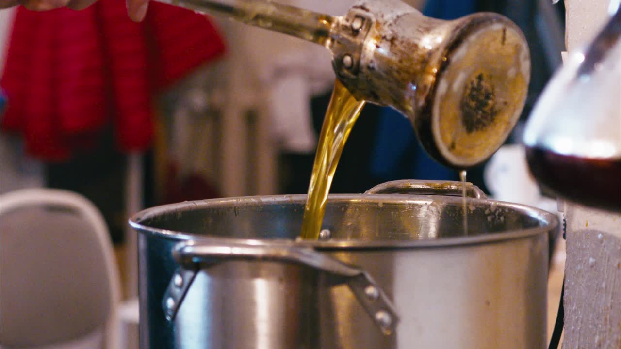 Premium stock video - Liquid wax poured out of metal jar