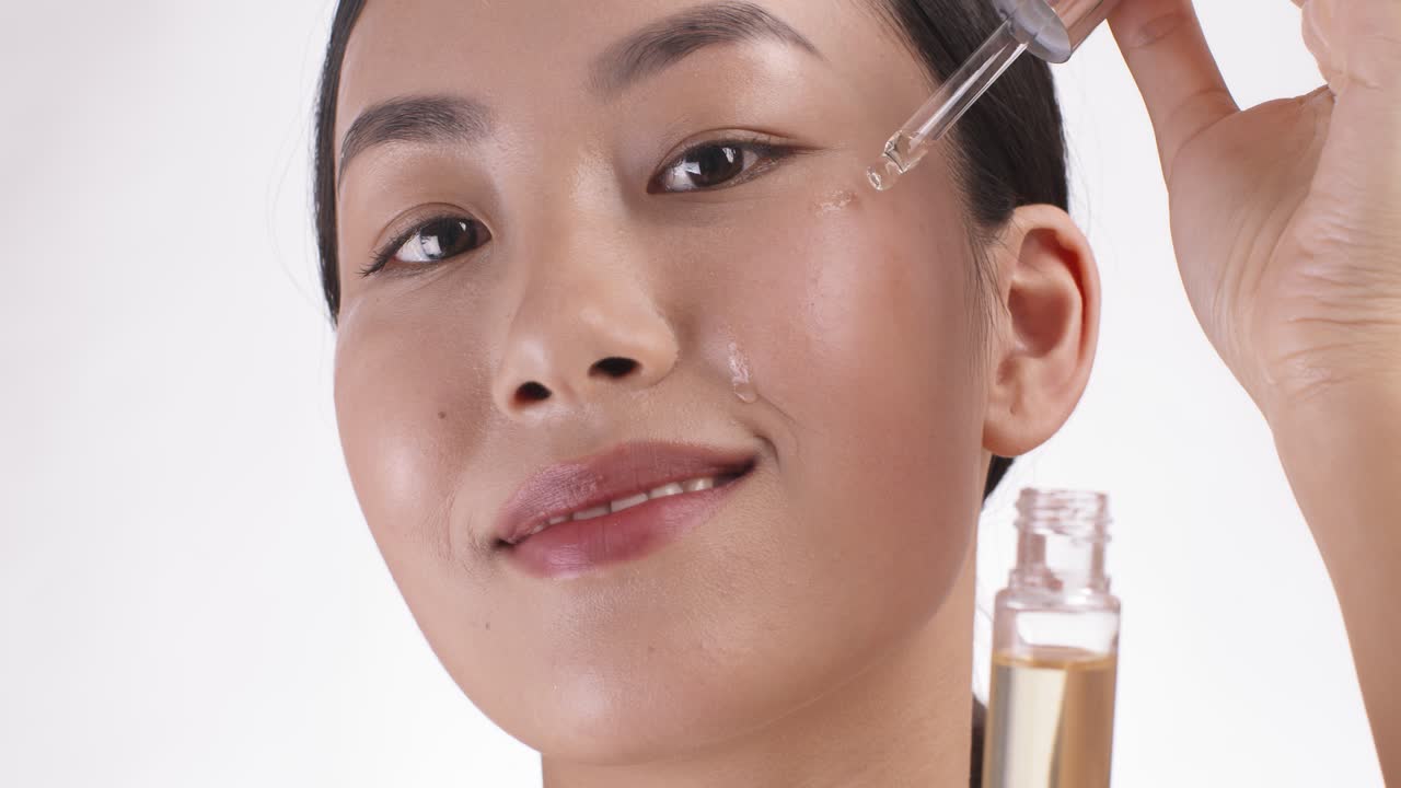 Woman Applying Facial Oil | Premium Stock Video Footage