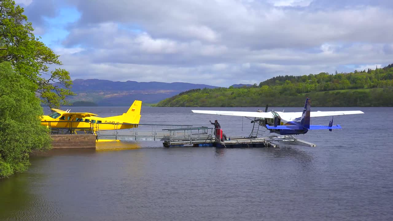 Premium stock video - Float planes sit on a small bay on loch lomand ...