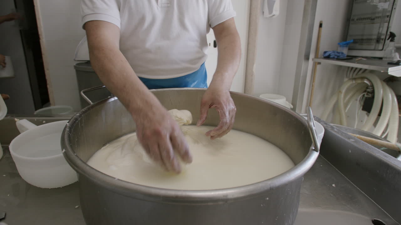 A Cheesemaker In Italy Pulling And Folding And Stretching A Large Batch ...