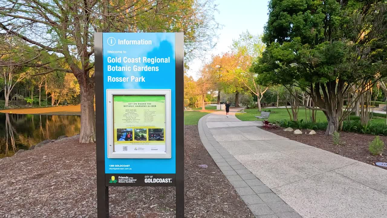 Pathway and sign in botanical gardens | Premium Stock Video Footage