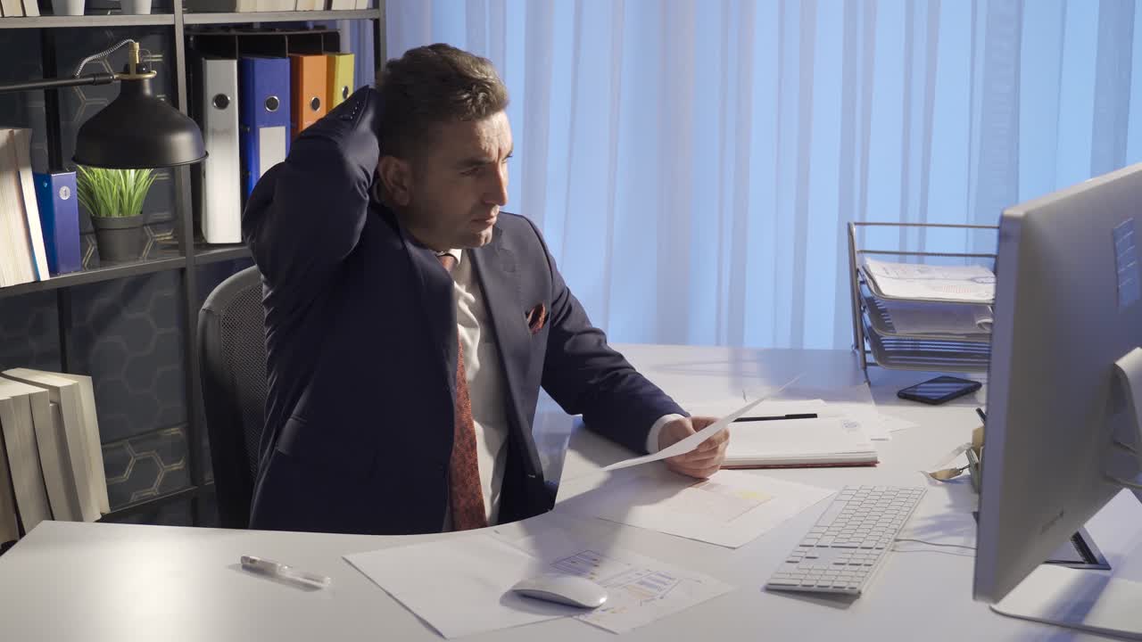 Premium stock video - Businessman struggling with sleep while working ...