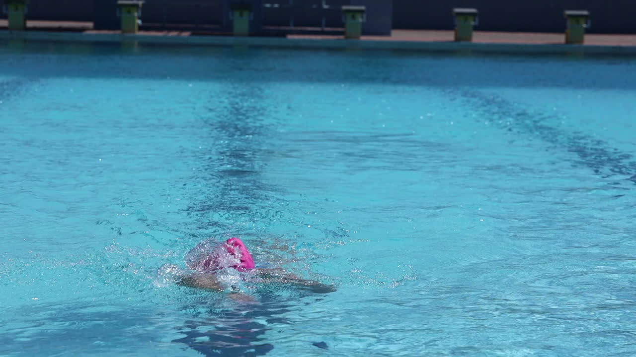 Footage Of A Female Swimmer Swimming Laps In An Outdoor Pool Using The ...